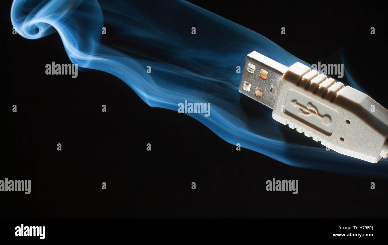 USB computer connector that is smoking on a black background Stock ...