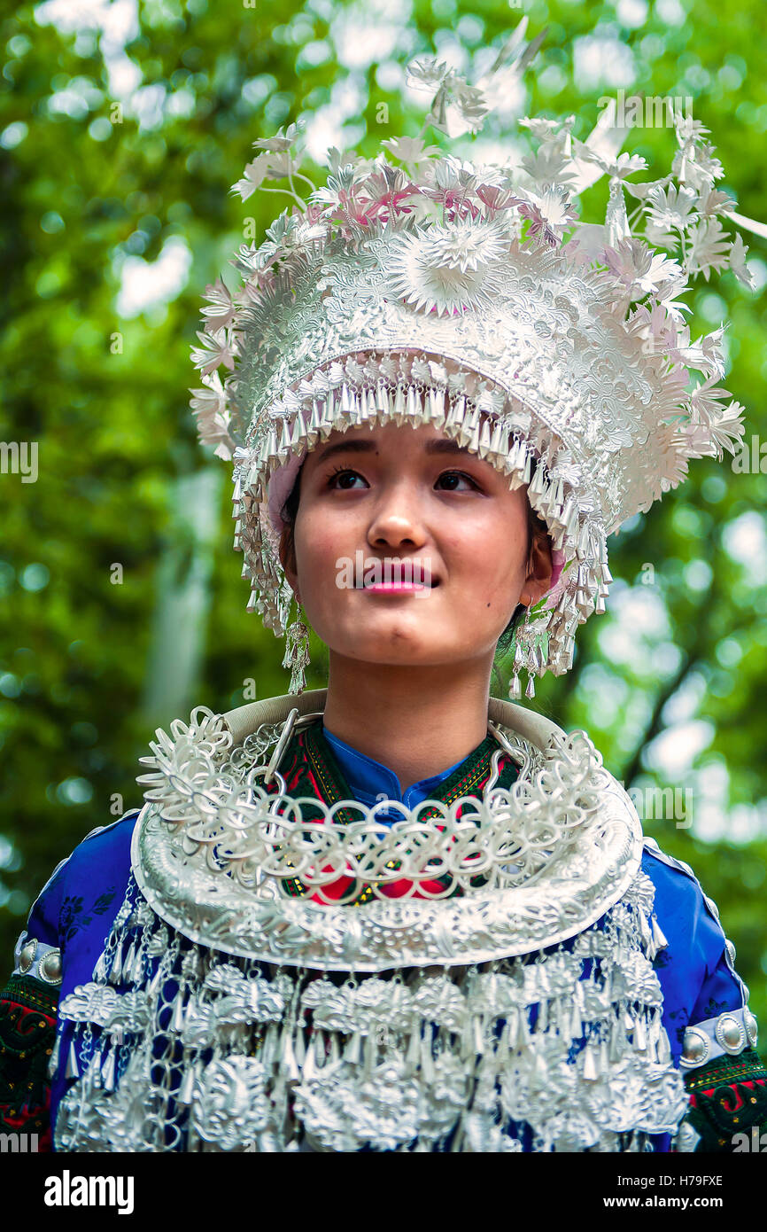 A Miao girl dressed in a traditional costume before the parade of the ...
