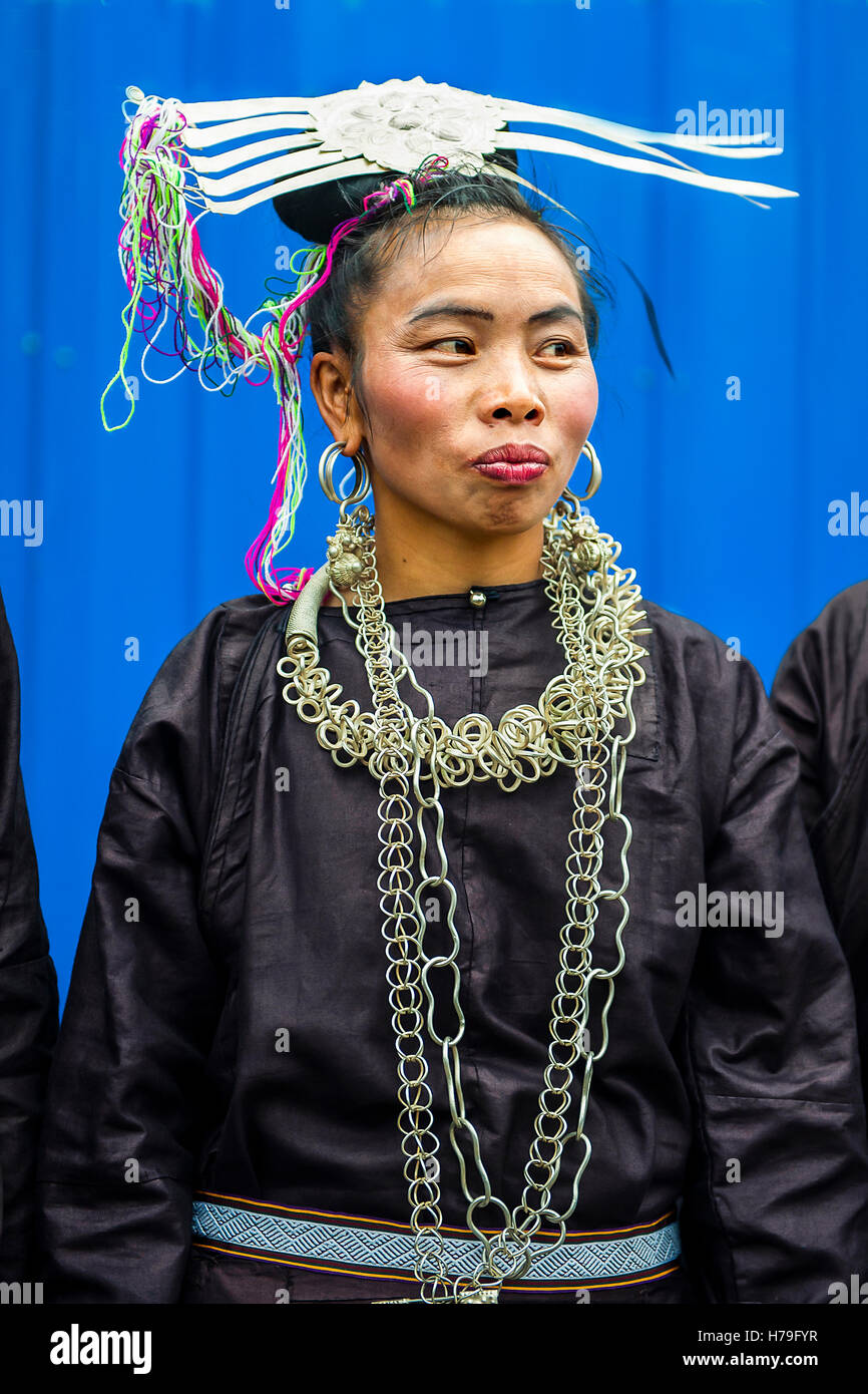 A girl in traditional Miao costume is preparing for the parade of ...