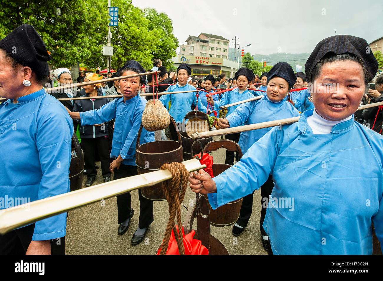 Women in traditional Miao costumes parade along the principal street of ...