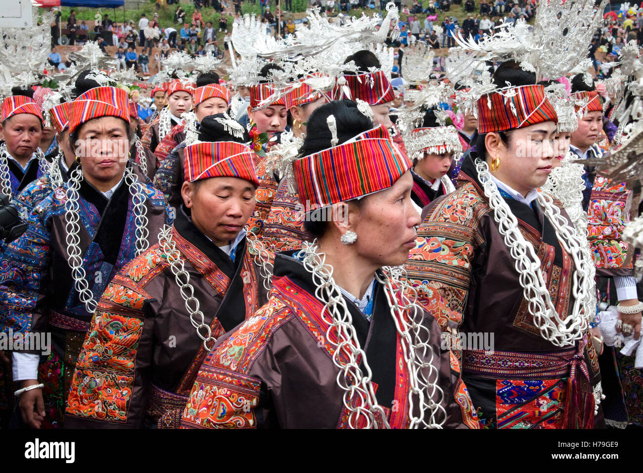 The parade of the Miao women dressed in traditional costumes along the ...