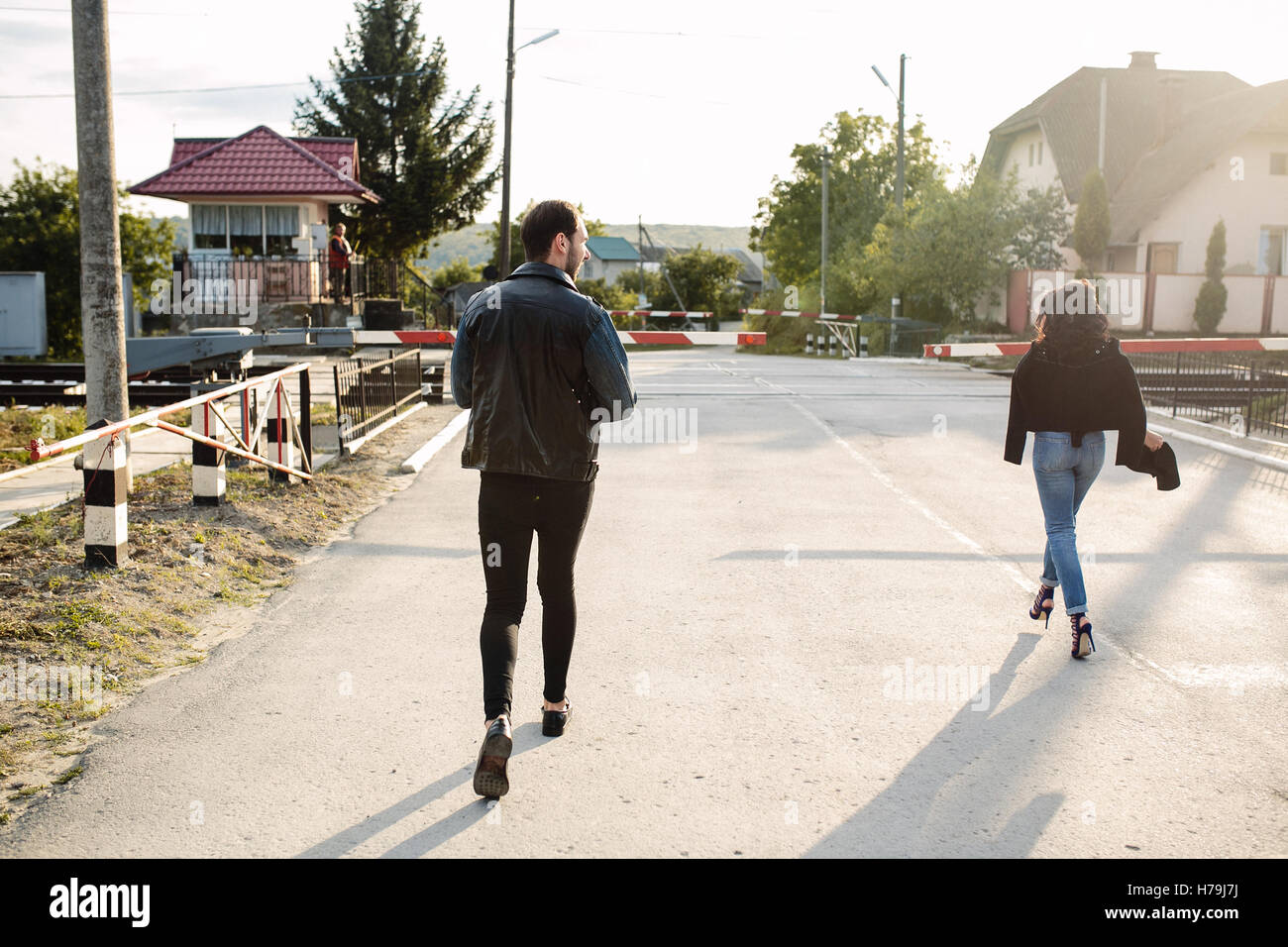 man and woman running to the railroad crossing Stock Photo - Alamy