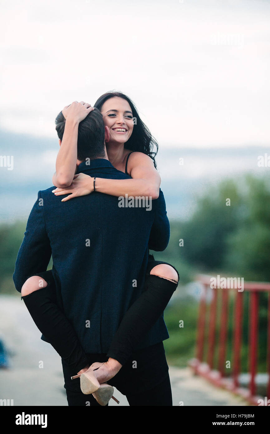 man holding his girlfriend on hands Stock Photo - Alamy