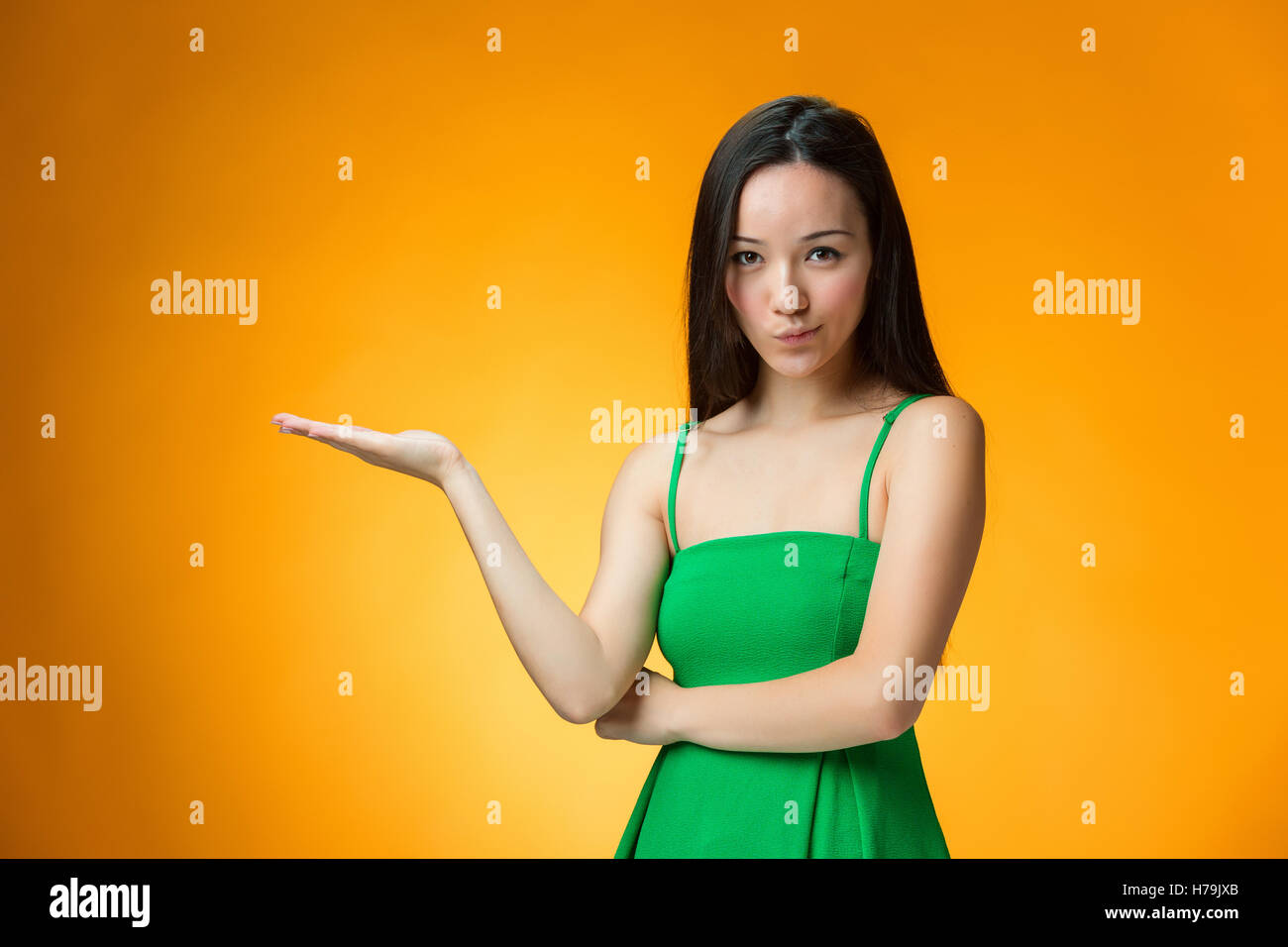 The happy Chinese girl on yellow background Stock Photo - Alamy