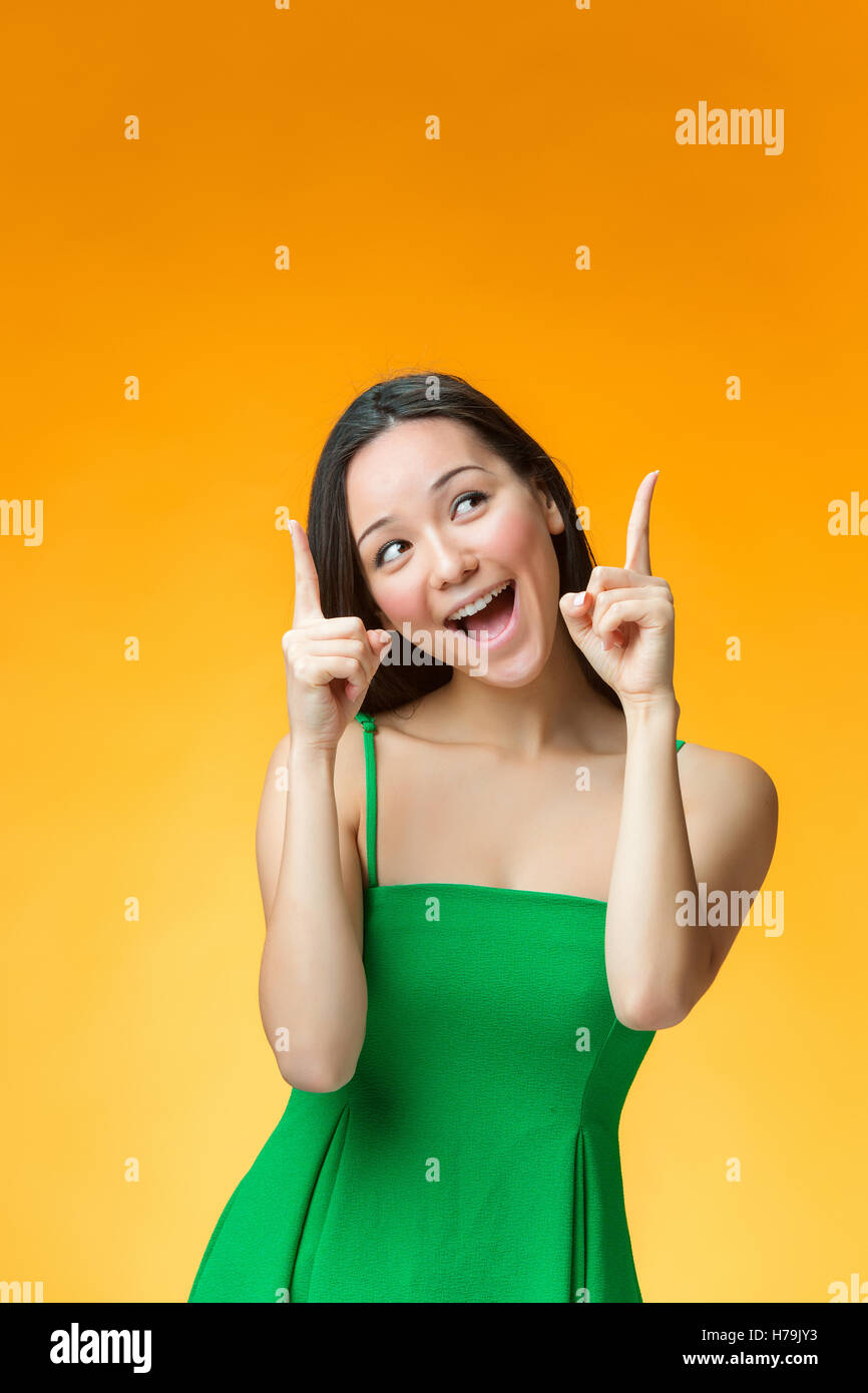 The happy Chinese girl on yellow background Stock Photo - Alamy