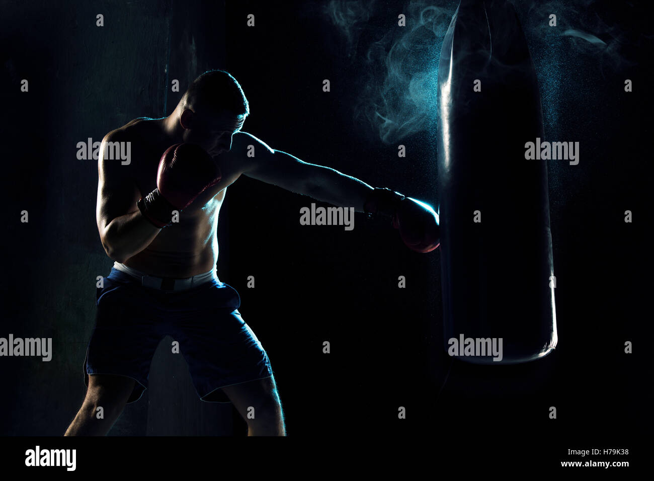 Male boxer boxing in punching bag Stock Photo - Alamy