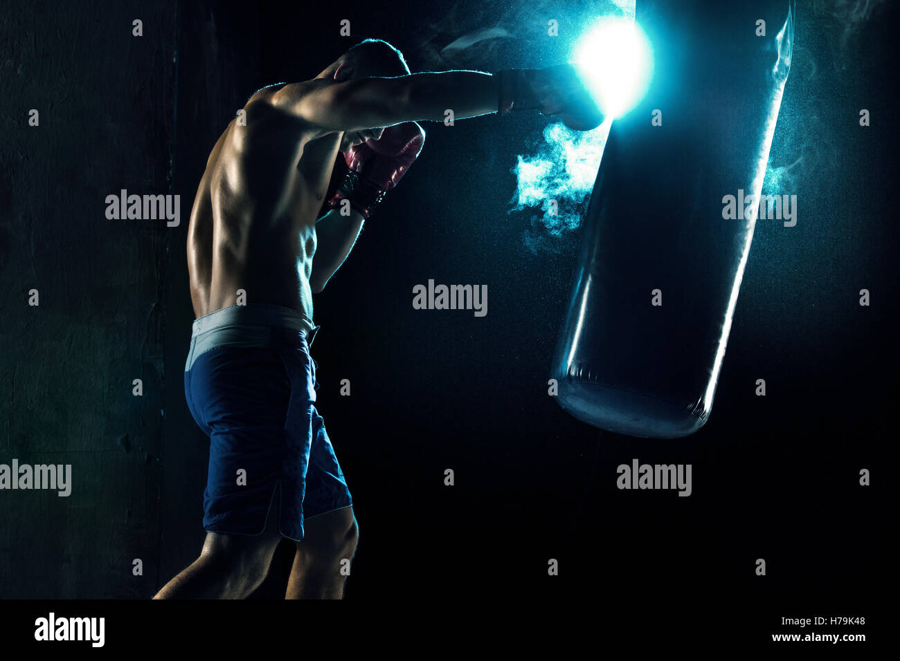 Male boxer boxing in punching bag Stock Photo - Alamy