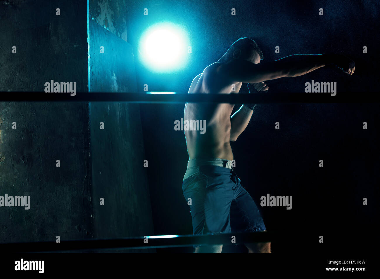 Male boxer boxing in a dark studio Stock Photo - Alamy