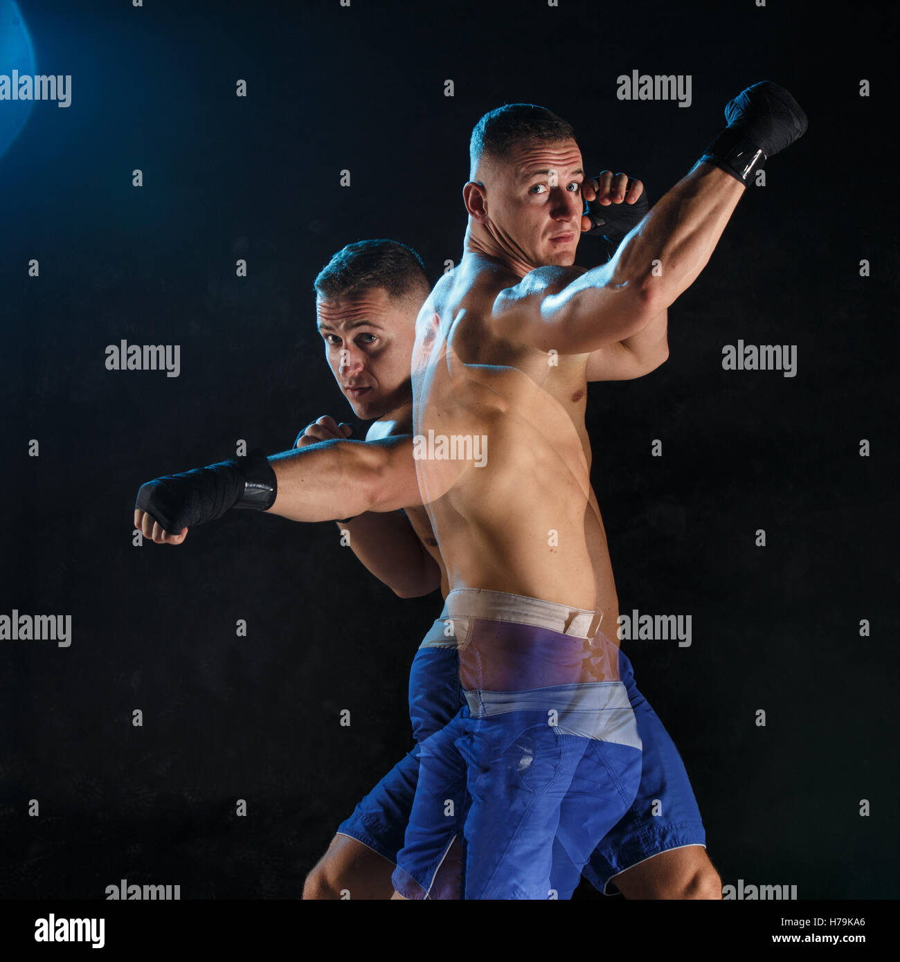 Male boxer boxing in a dark studio Stock Photo - Alamy