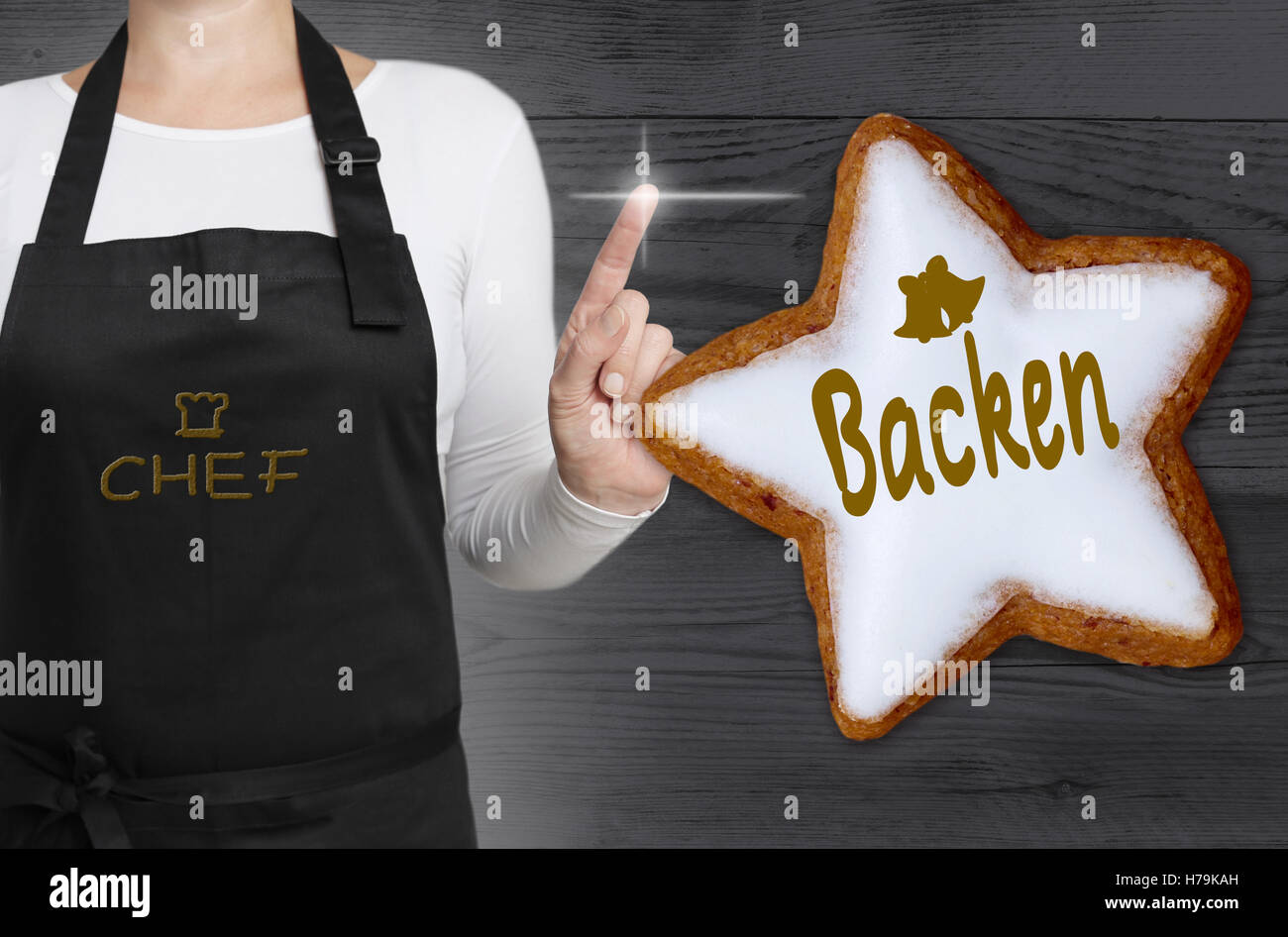 Backen (in german baking) cinnamon star is shown by chef Stock Photo ...