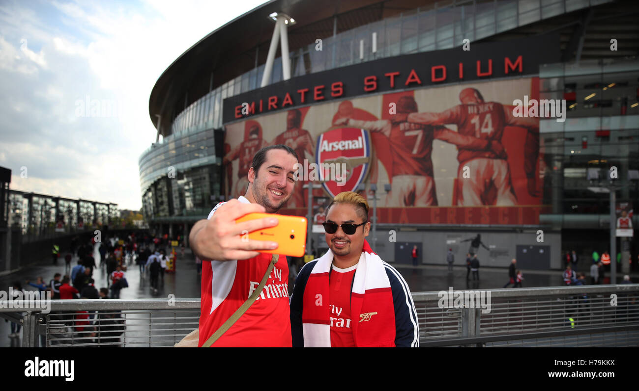 Arsenal fans pose for a photograph outside the ground Stock Photo - Alamy