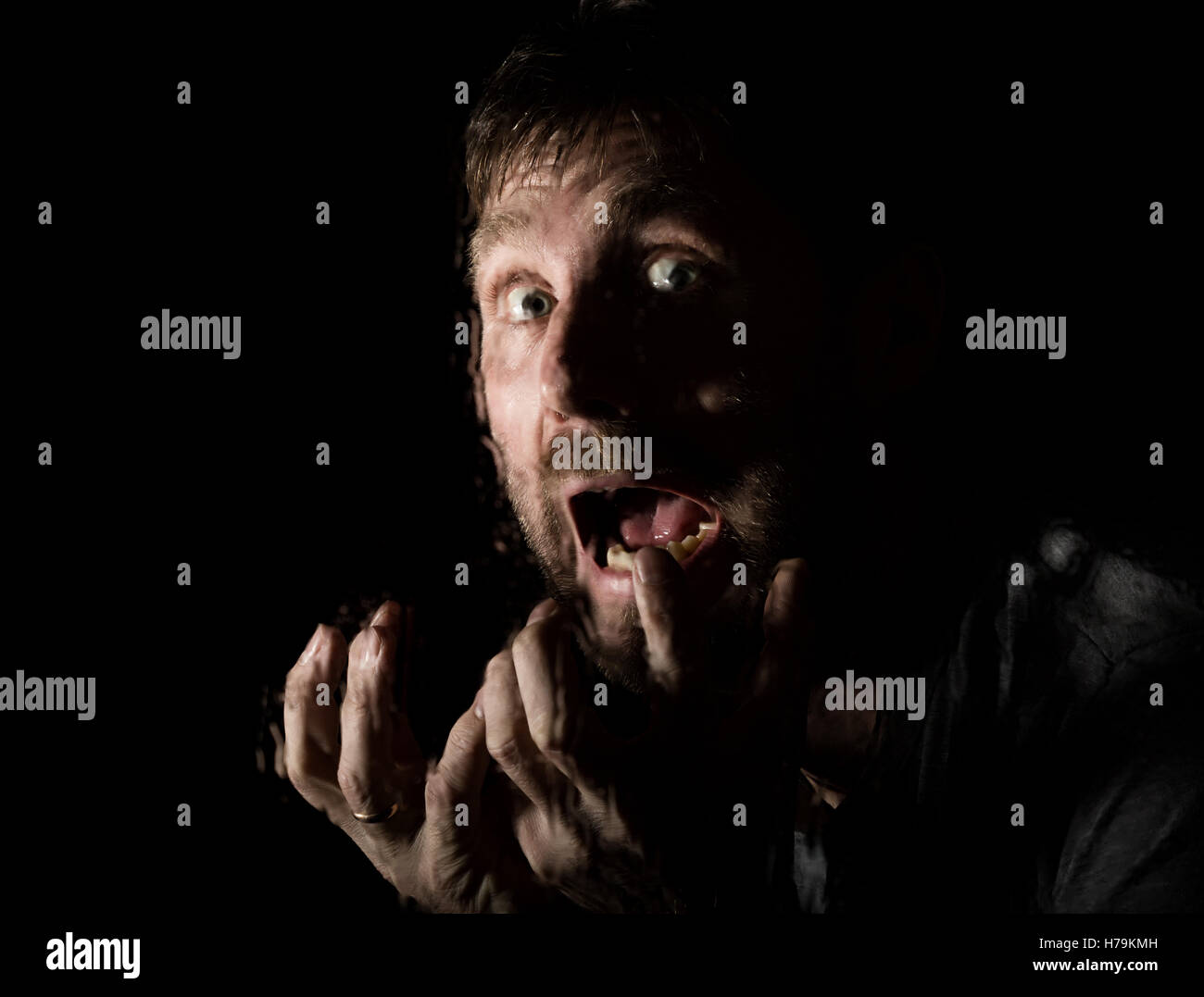 Dark portrait of scary bearded man with smirk, expresses different ...