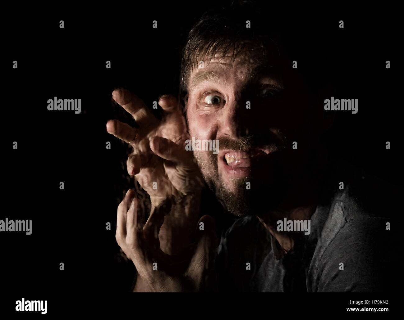 Dark portrait of scary bearded man with smirk, expresses different ...