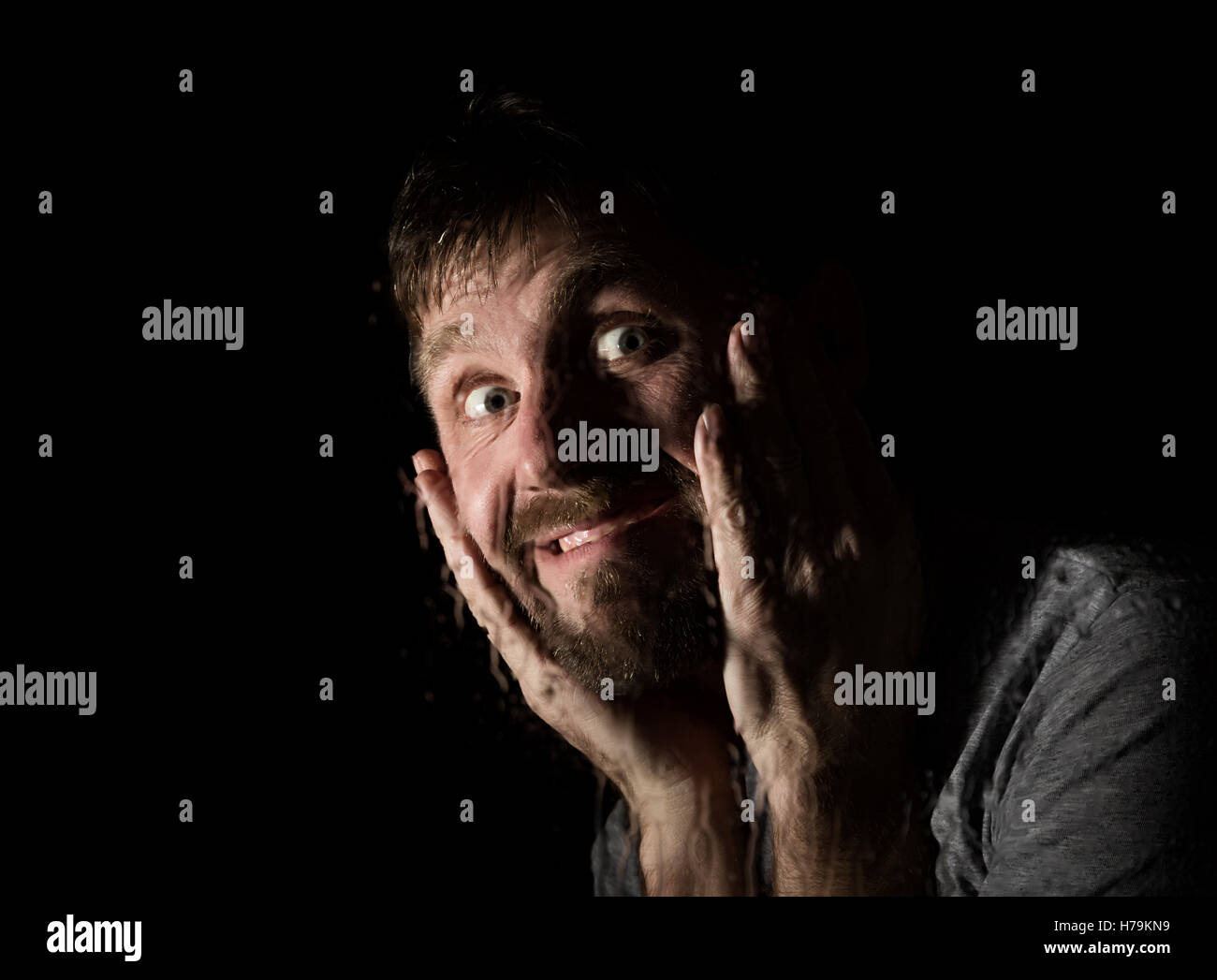 Dark portrait of scary bearded man with smirk, expresses different ...