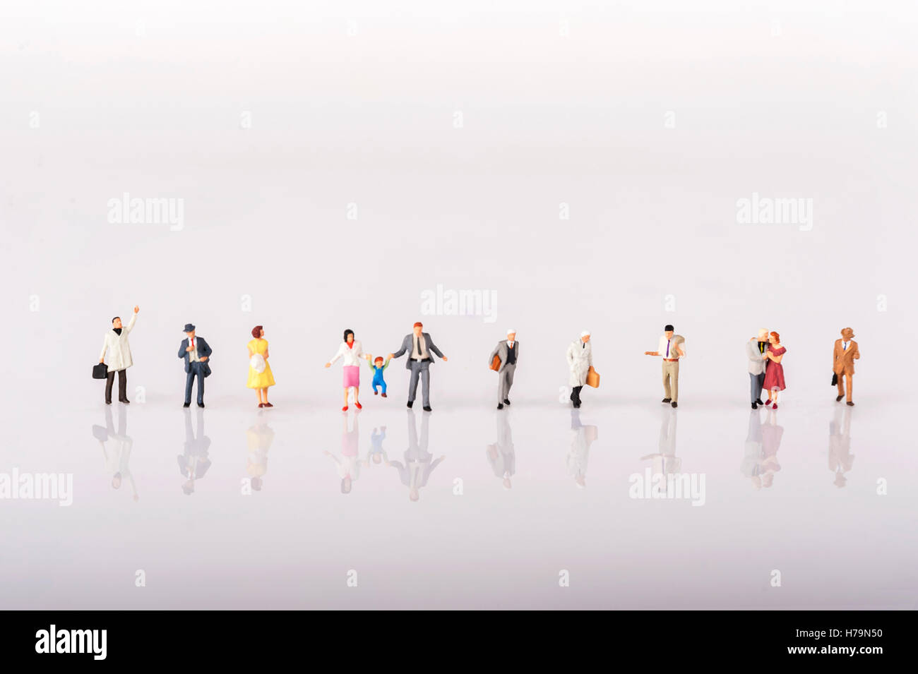 Line of diverse tiny miniature model people Stock Photo - Alamy