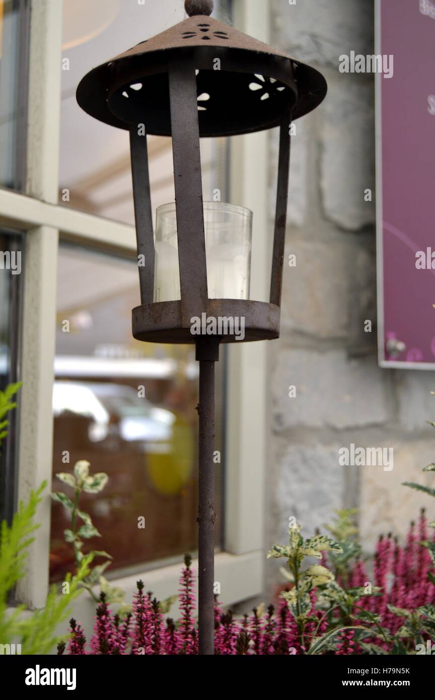 rusty lamp post for lamp with a candle placed in a flower pot Stock ...