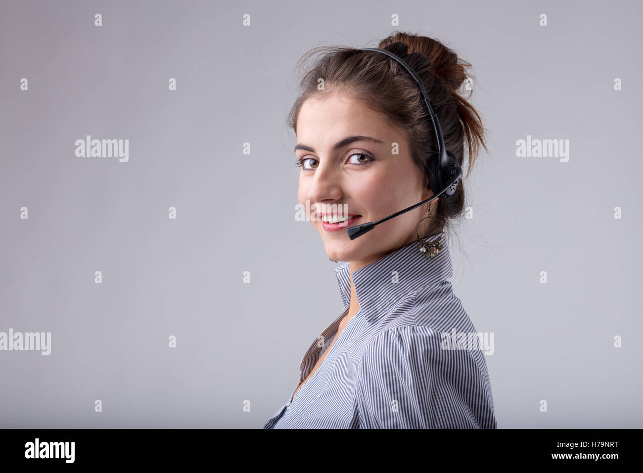 Attractive call center operator or businesswoman wearing a headset ...