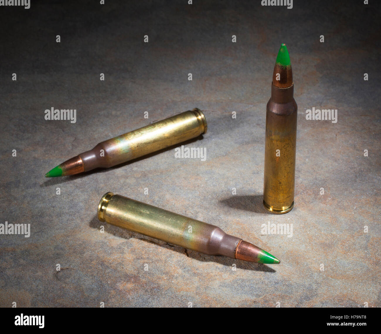 Ammunition with green tipped bullets on a rock background Stock Photo ...