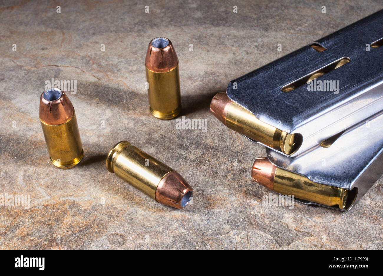 Bullets with hollow points for a handgun with magazines Stock Photo - Alamy