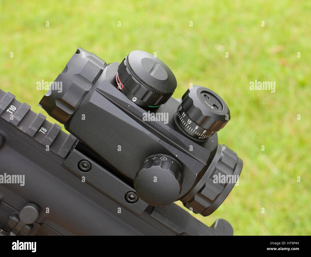 Low magnification scope mounted on a rifle with a green background ...
