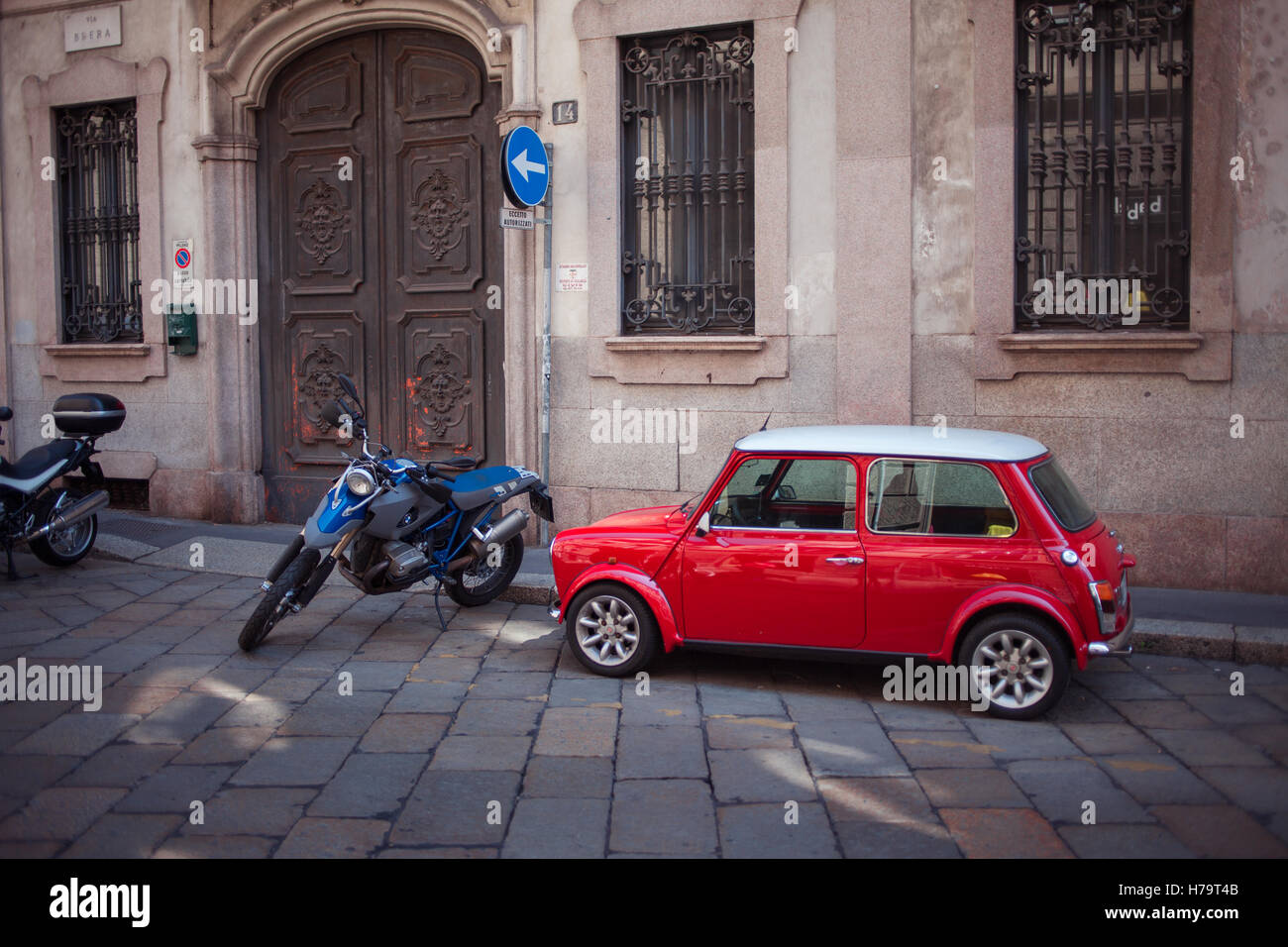 MILAN, ITALY-MAY 28, 2012: little red car and motorcycle, features of ...
