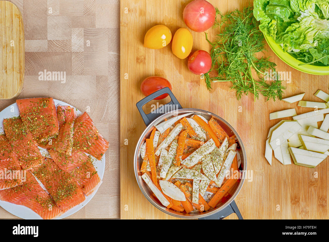 Salmon fish preparation for cooking, chopped vegetables, salt and knife ...