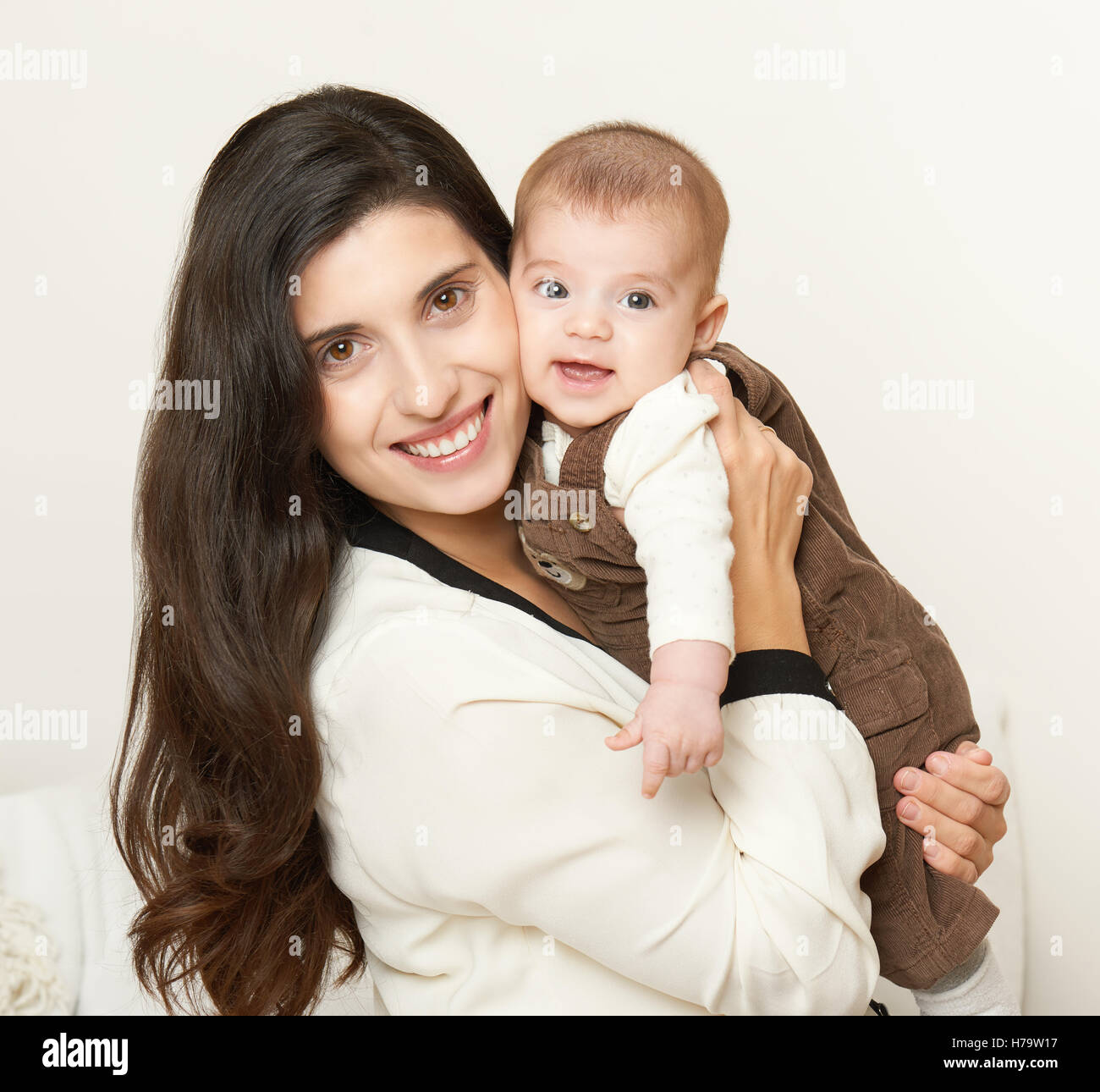 Mother raising baby and play, happy family portrait on white background ...