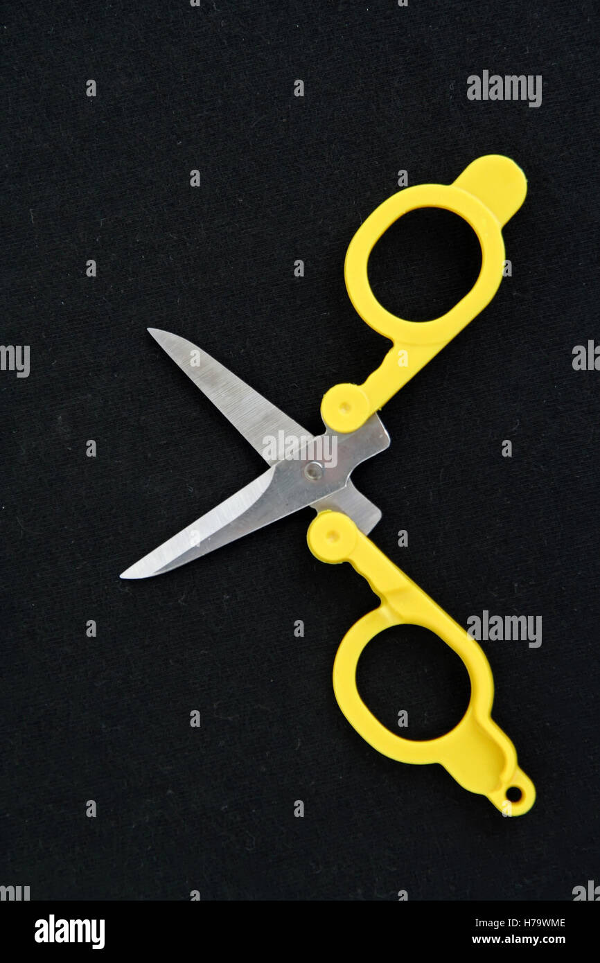 Small yellow scissors. Small home scissors Stock Photo - Alamy