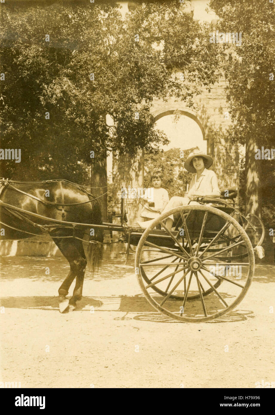 Woman and child in a horse carriage, Italy Stock Photo - Alamy