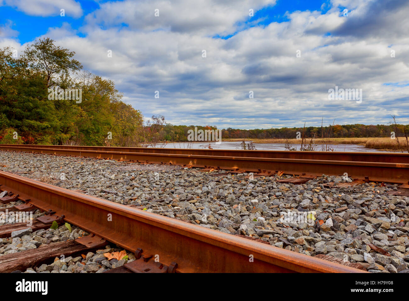 Railroad blue sky and cloudy sky clouds railroad Stock Photo - Alamy