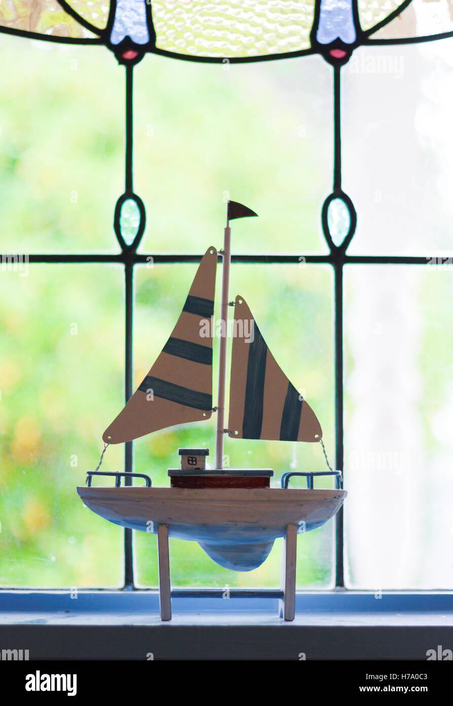 nautical decor in beach house - sailboat by the window Stock Photo - Alamy