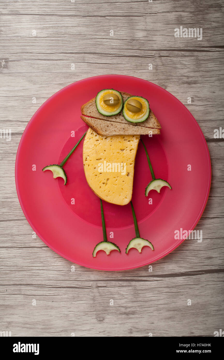 Amusing frog made of bread and vegetables on plate and desk Stock Photo ...