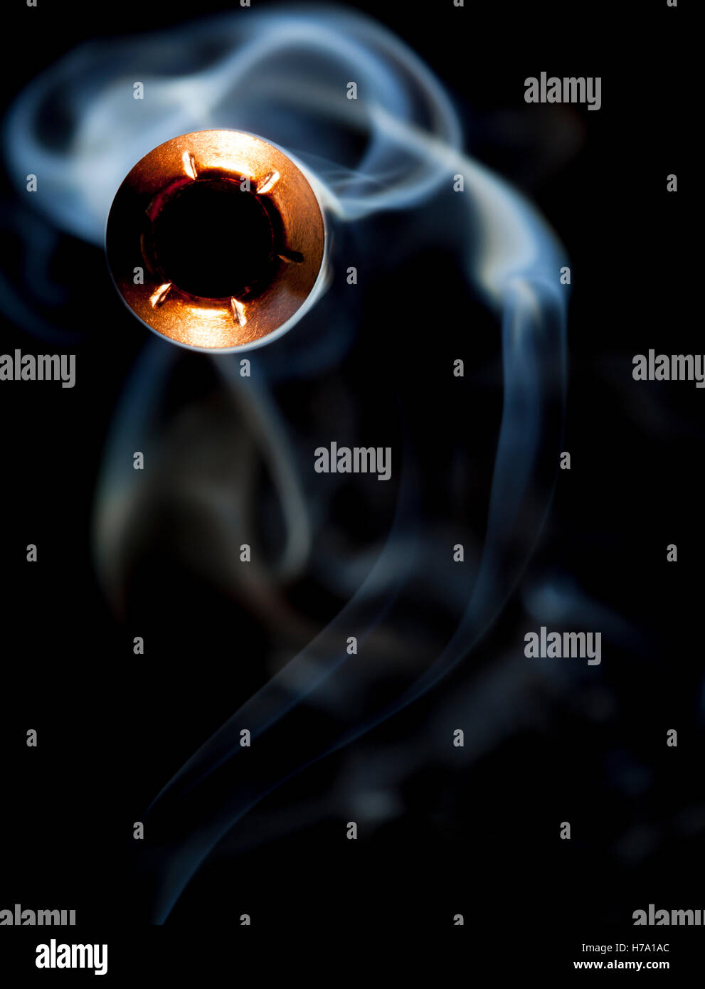 Copper color bullet and smoke on a black background Stock Photo - Alamy