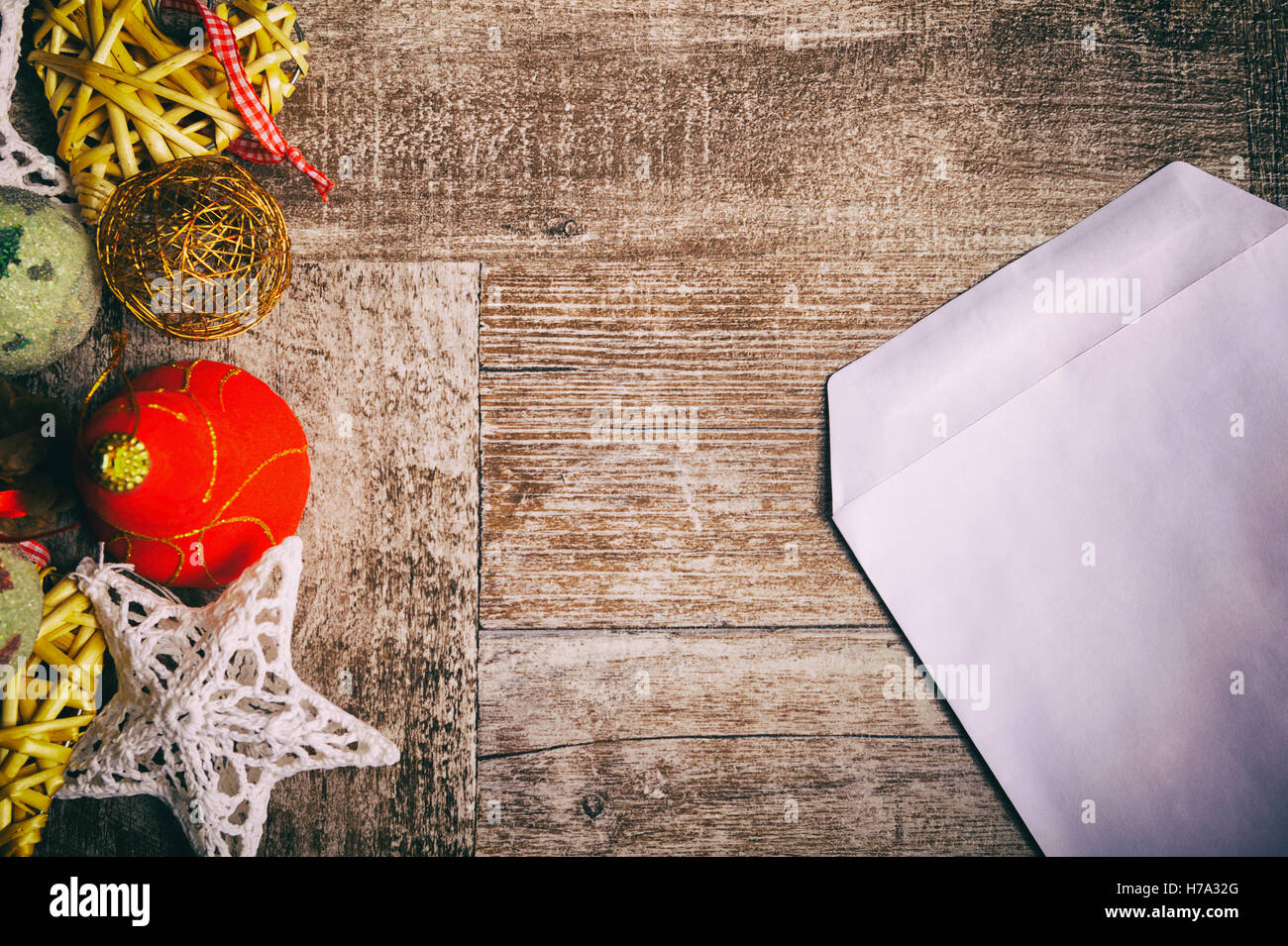 Christmas letter surrounded by ornaments in vintage toning on wooden ...