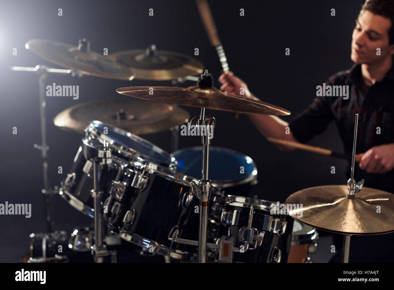 Side View Of Young Drummer Playing Drum Kit In Studio Stock Photo - Alamy