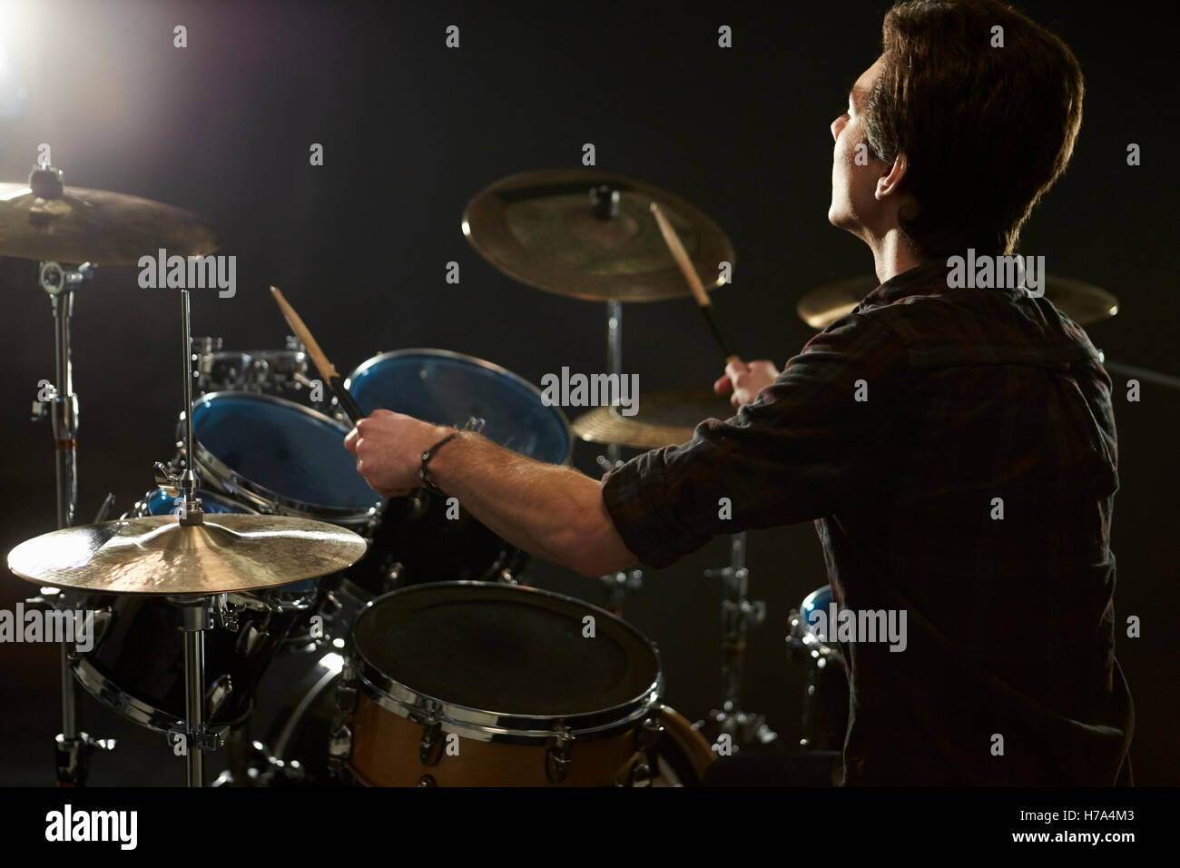 Rear View Of Drummer Playing Drum Kit In Studio Stock Photo - Alamy