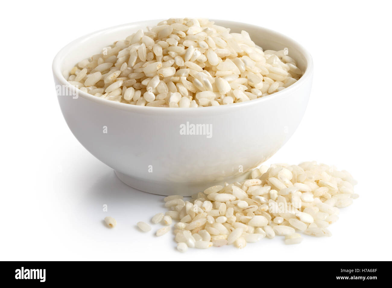 Bowl of Arborio short grain white rice isolated on white. Spilled rice ...