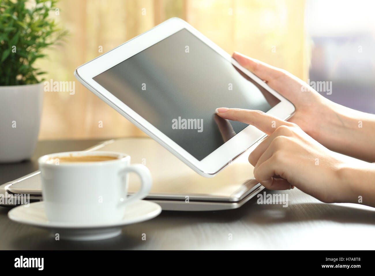 Close up of a girl hands using a tablet touching the screen with the ...