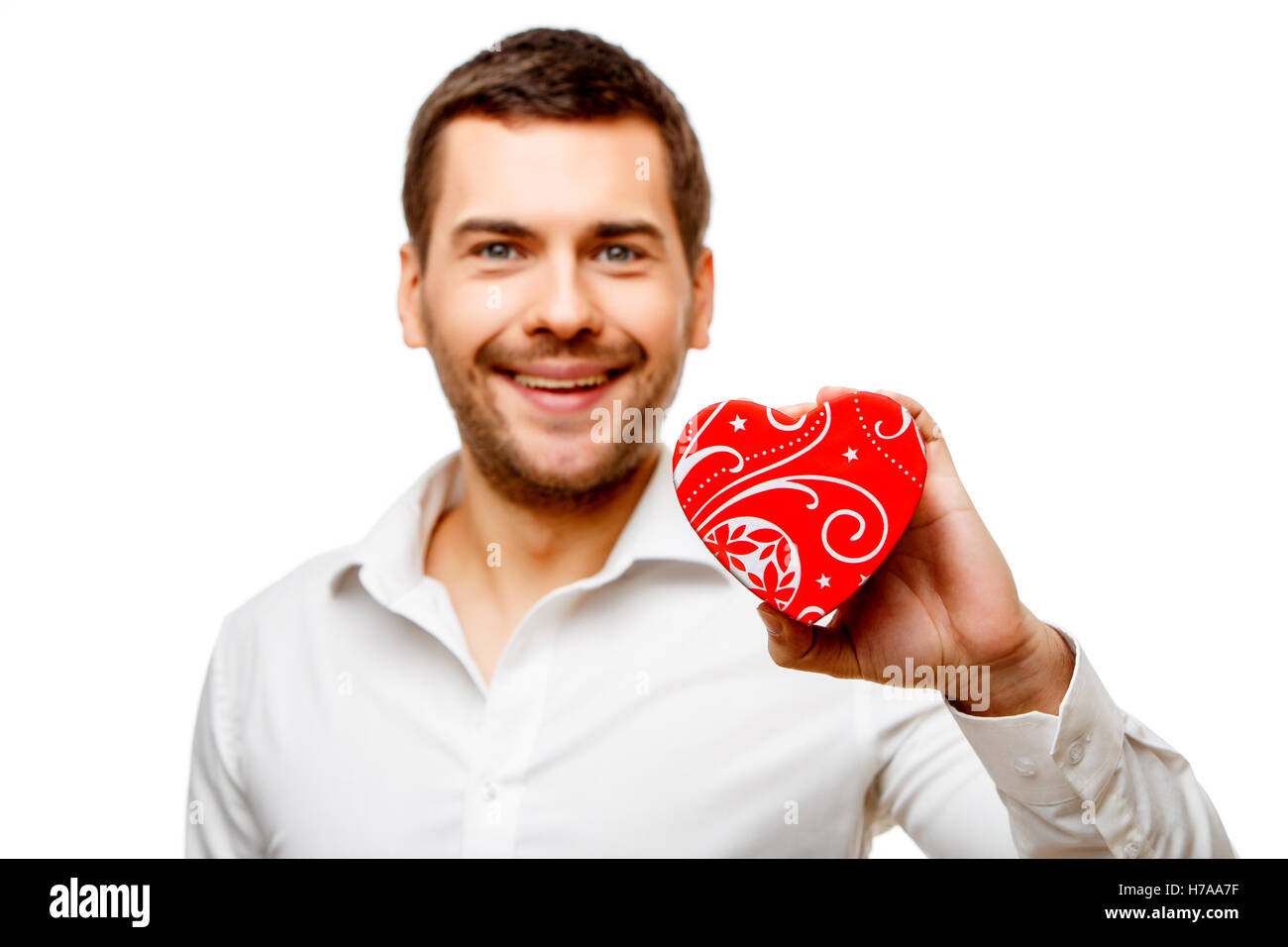 Young man carries heart shaped box Stock Photo - Alamy