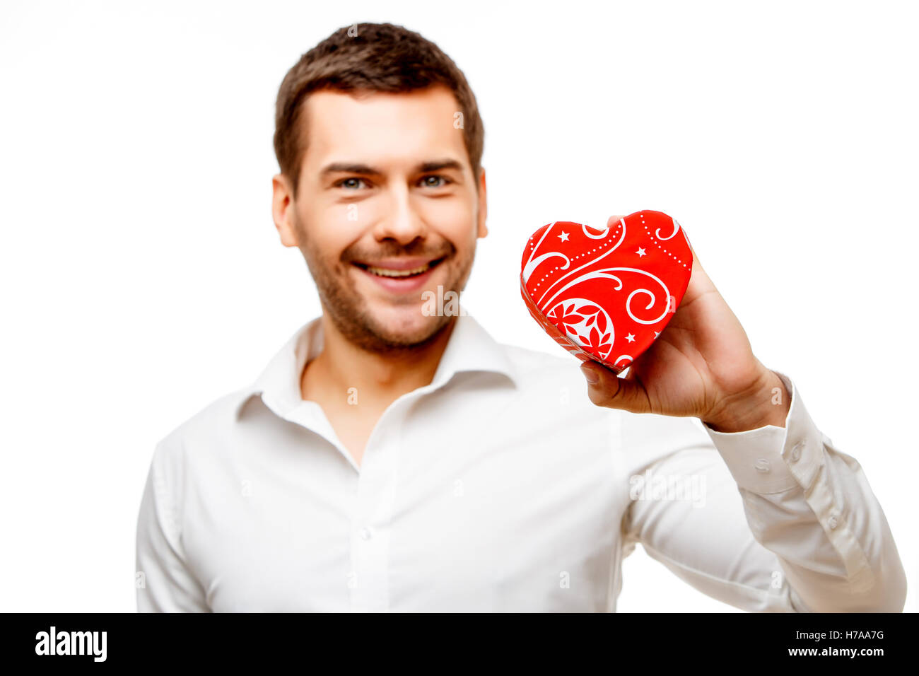 Young man carries heart shaped box Stock Photo - Alamy