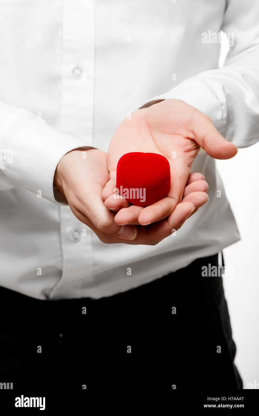 Young man presenting something in a small box Stock Photo - Alamy