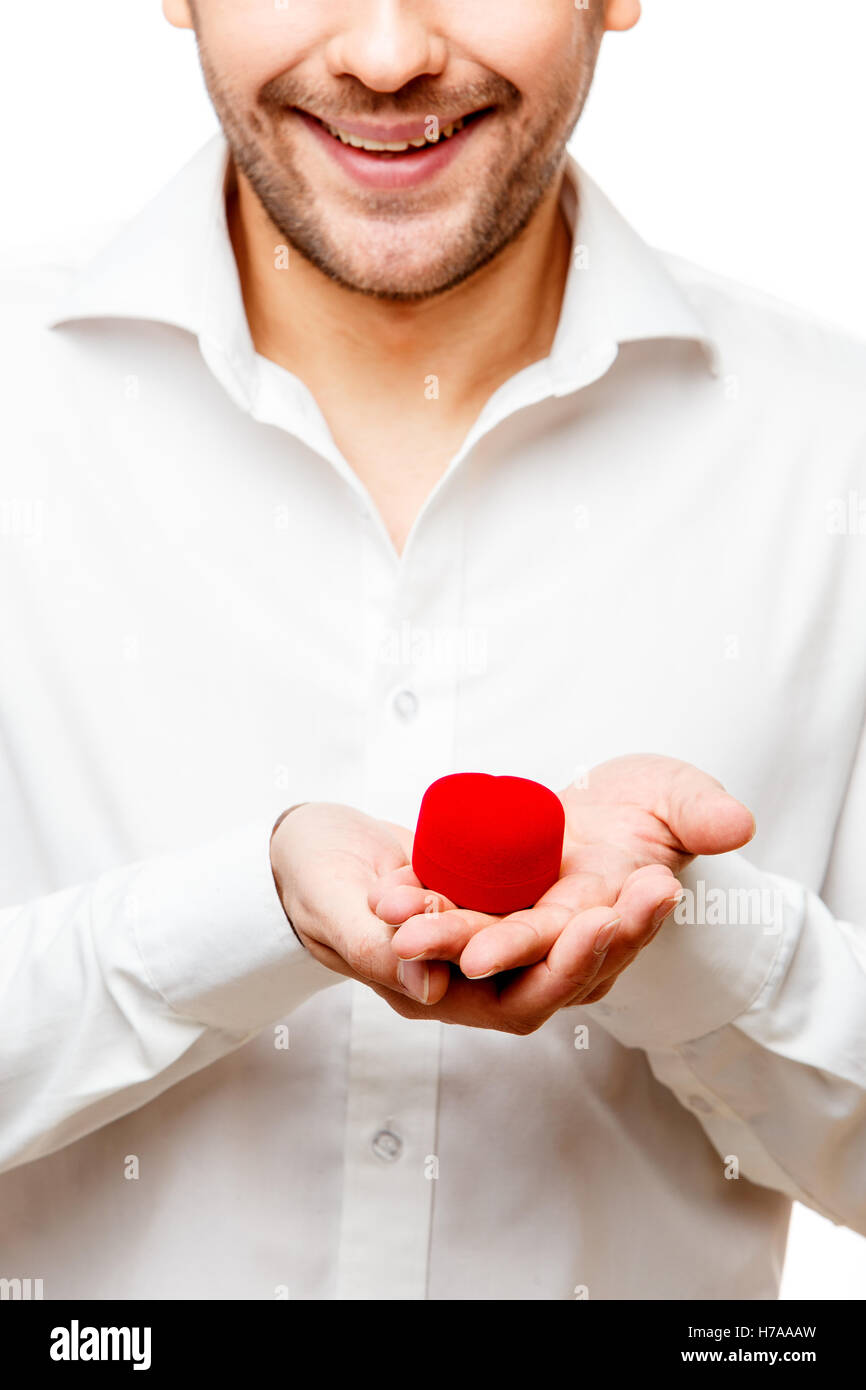 Young man presenting something in a small box Stock Photo - Alamy