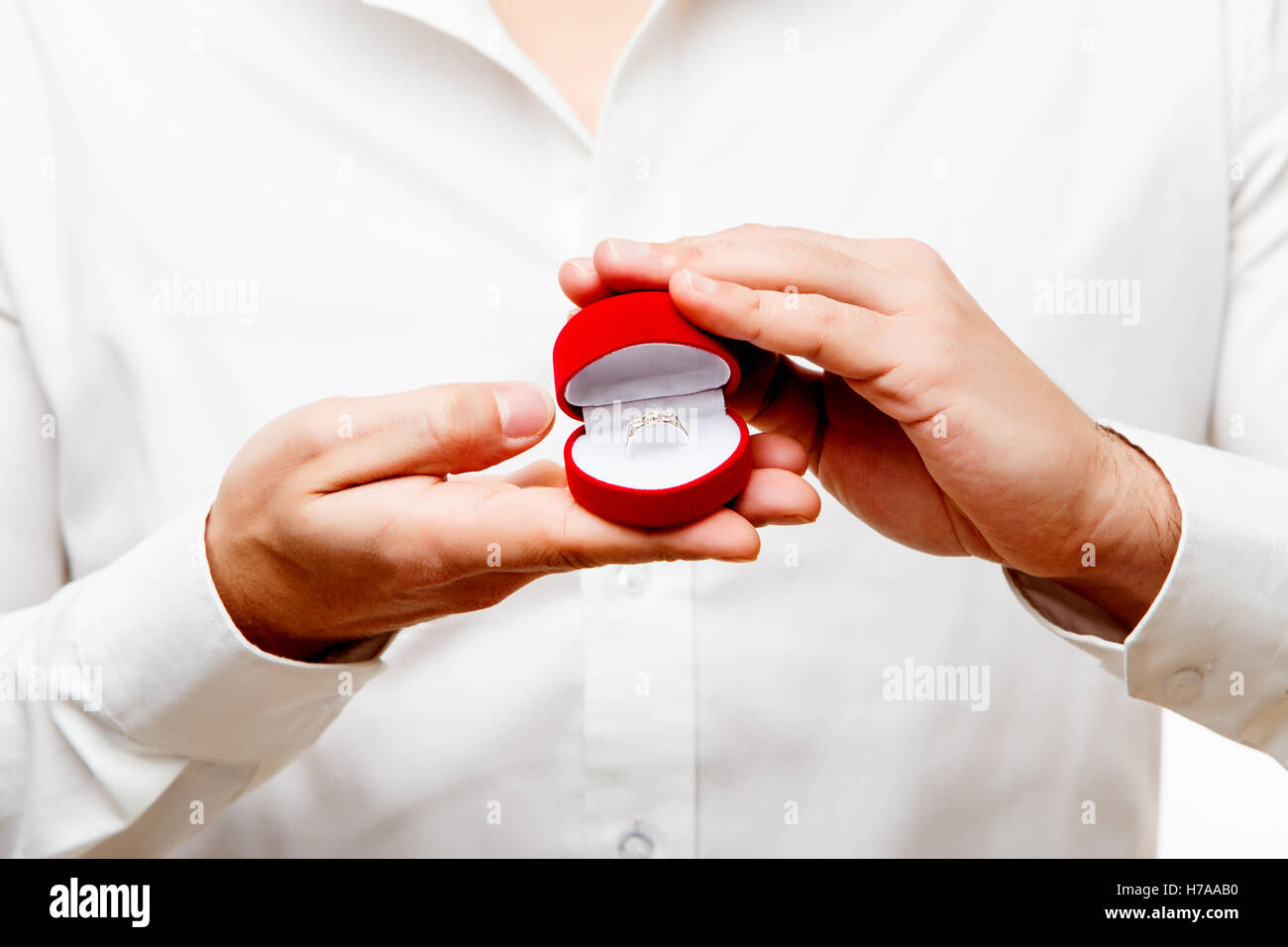Young man presenting something in a small box Stock Photo - Alamy