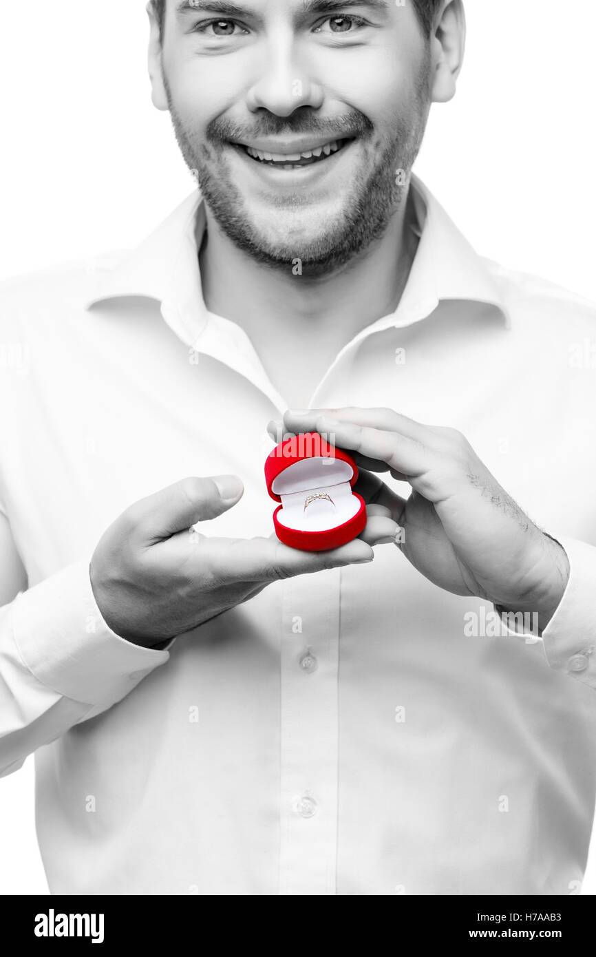 Young man presenting something in a small box Stock Photo - Alamy