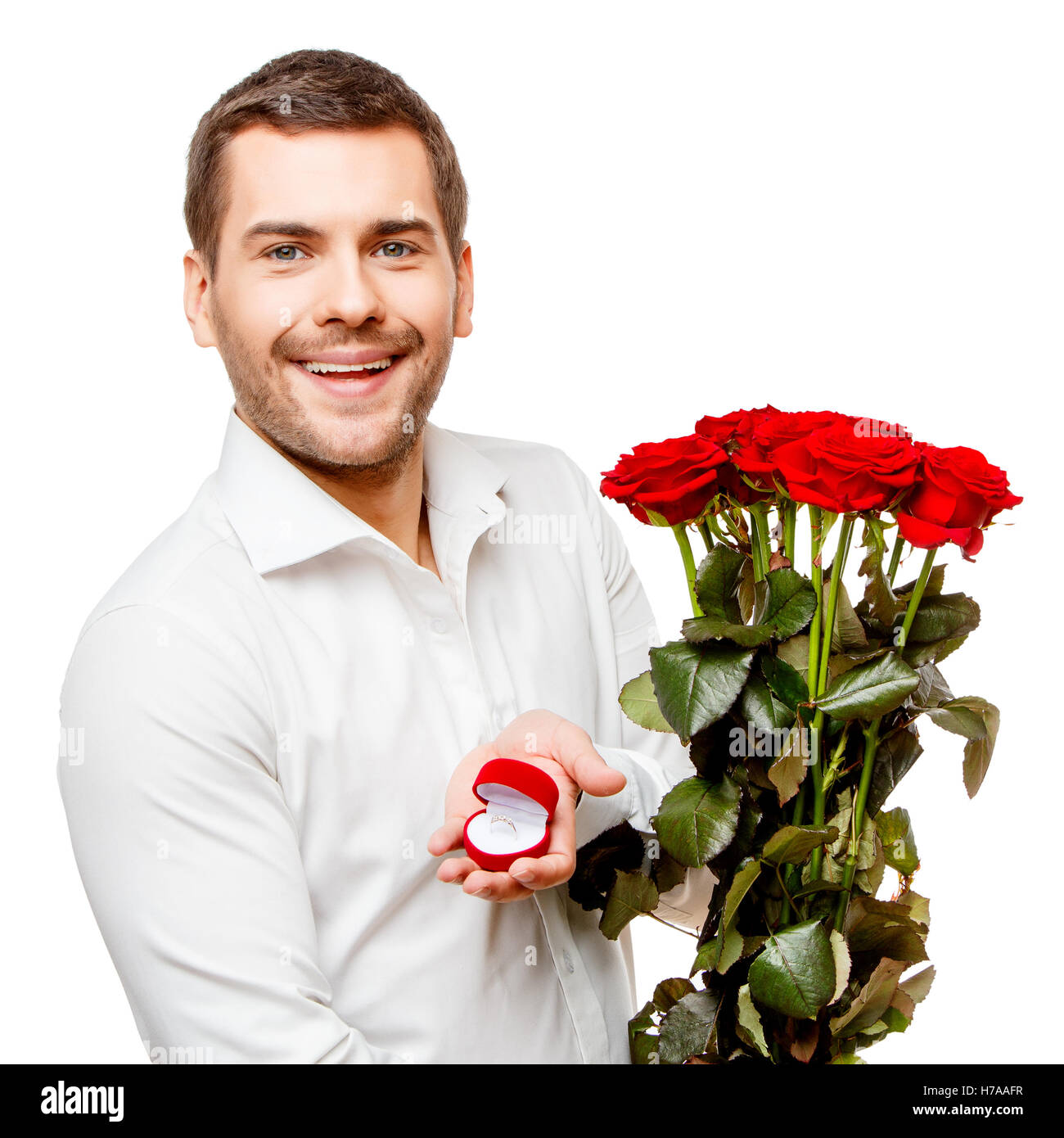 Young man carries heart shaped box and flowers Stock Photo - Alamy