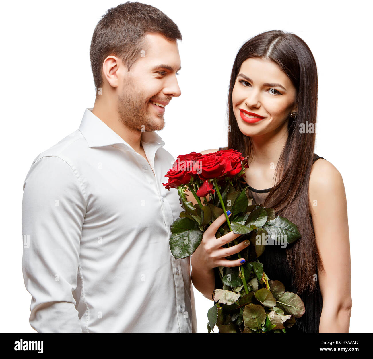 Young beautiful couple with flowers isolated on white Stock Photo - Alamy