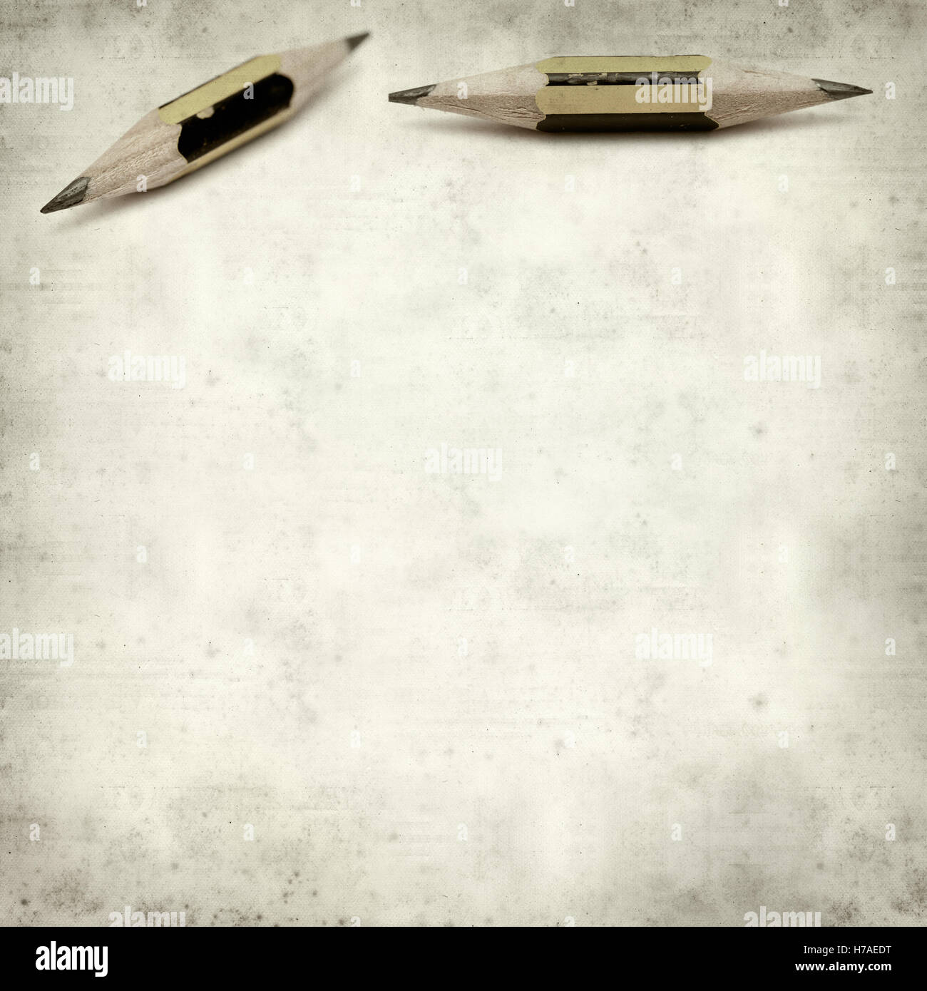 textured old paper background with very short pencil sharpened at both ...