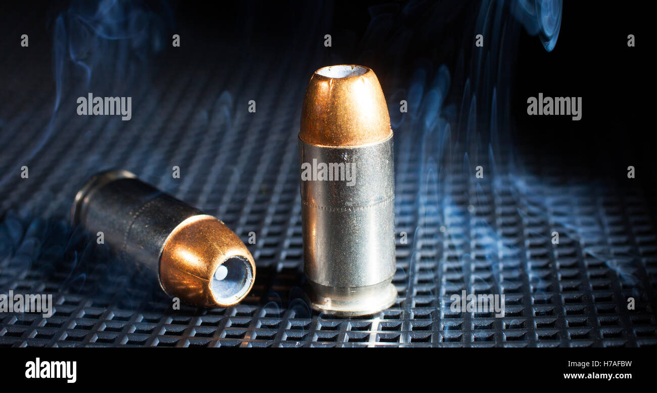 Two hollow points on a black background with smoke Stock Photo - Alamy