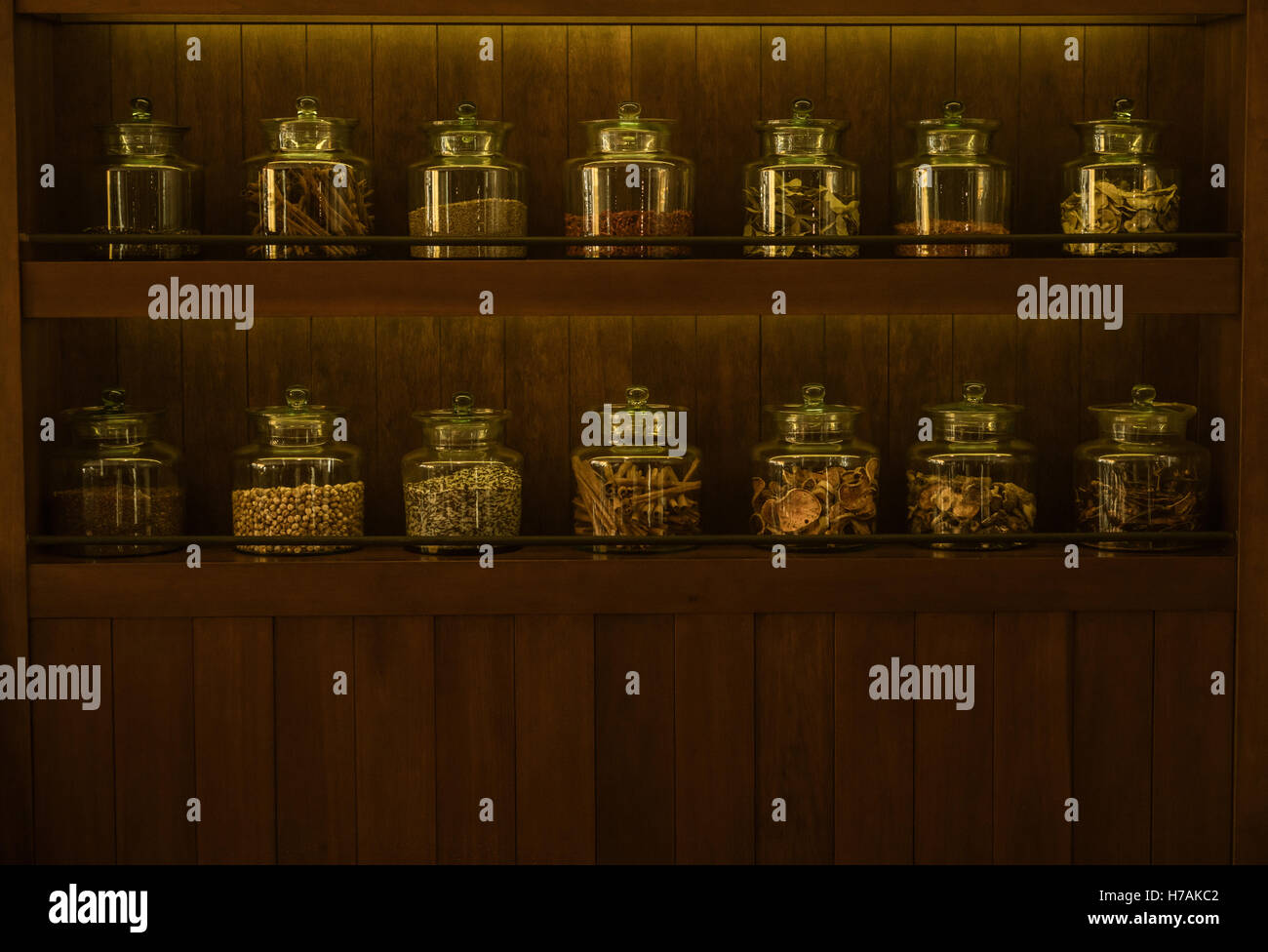 Arrangement of dry food products on dark wooden shelves. Home kitchen ...