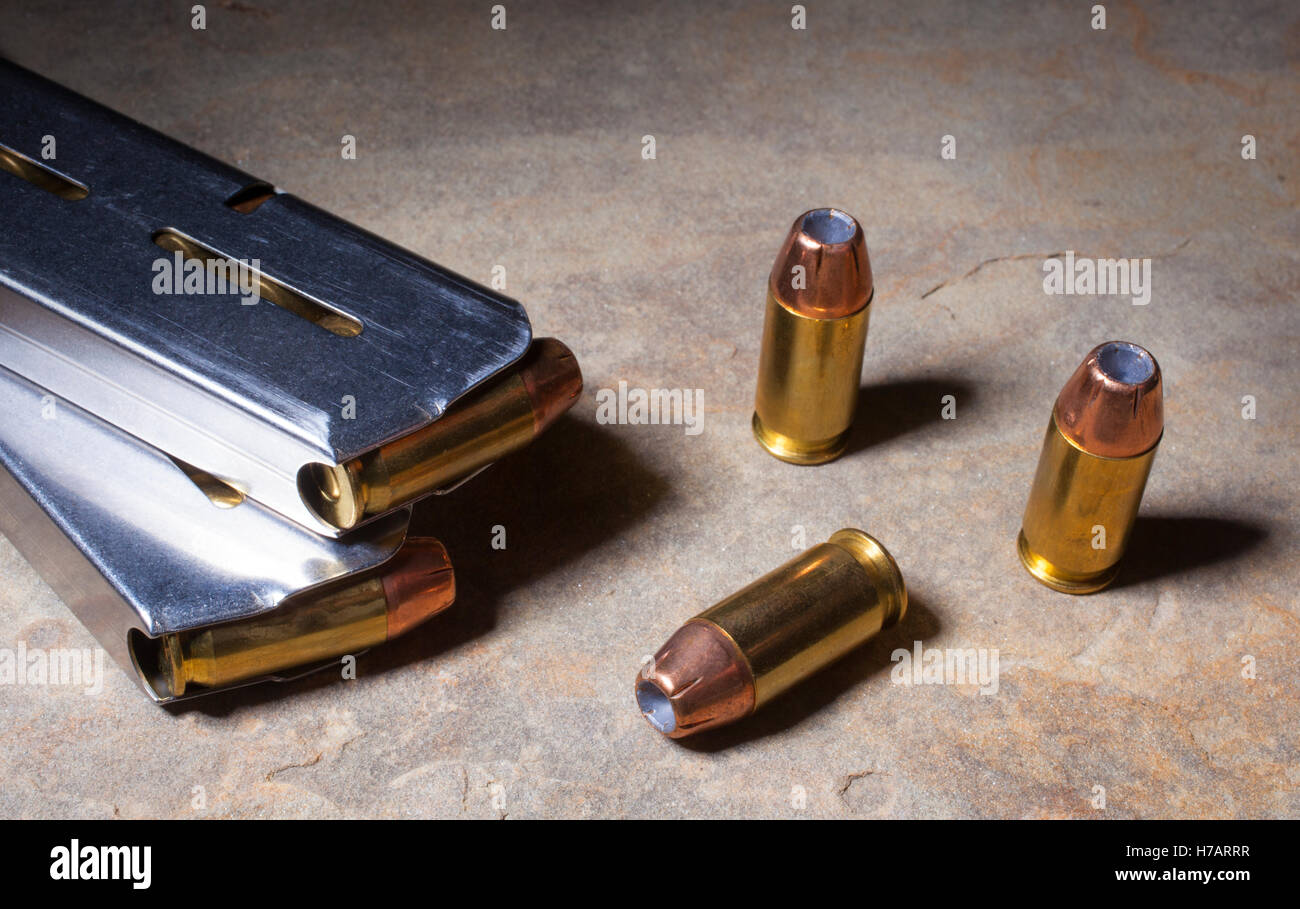 Cartridges with hollow point bullets and magazines for semi auto pistol ...